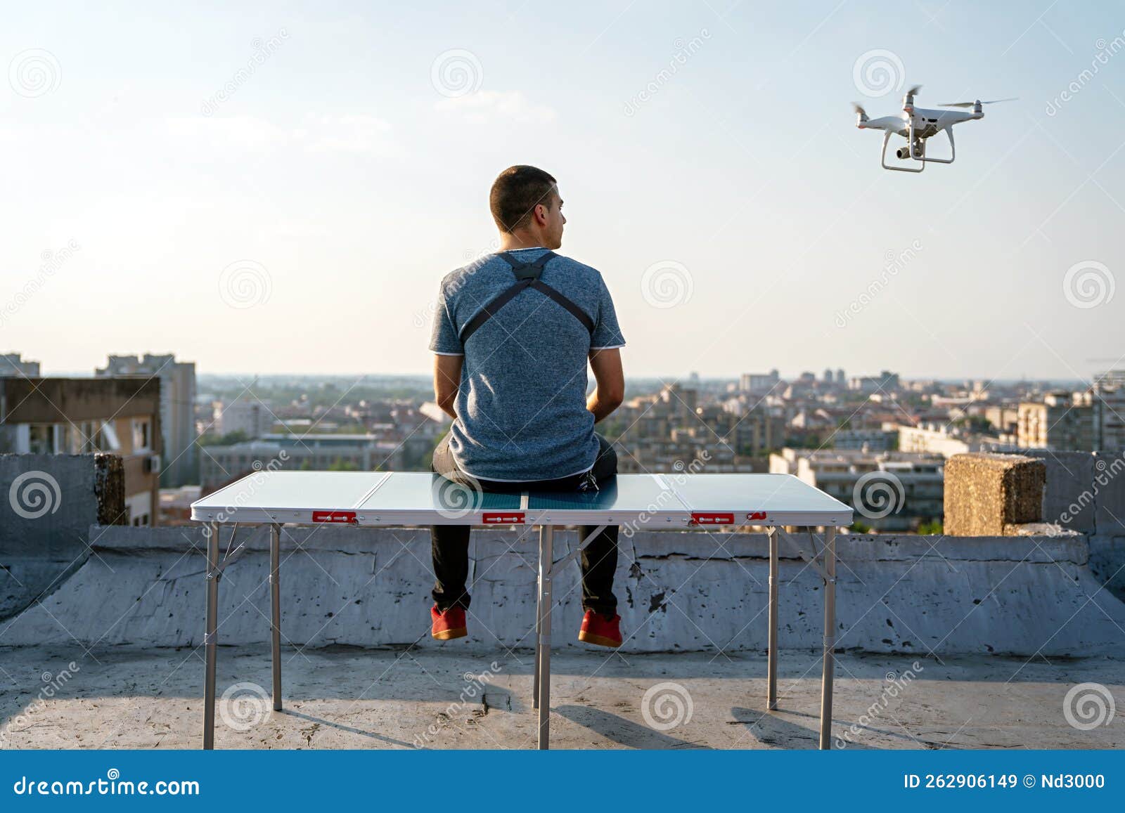 Young Technician Flying UAV Drone with Remote Control on Rooftop Stock ...