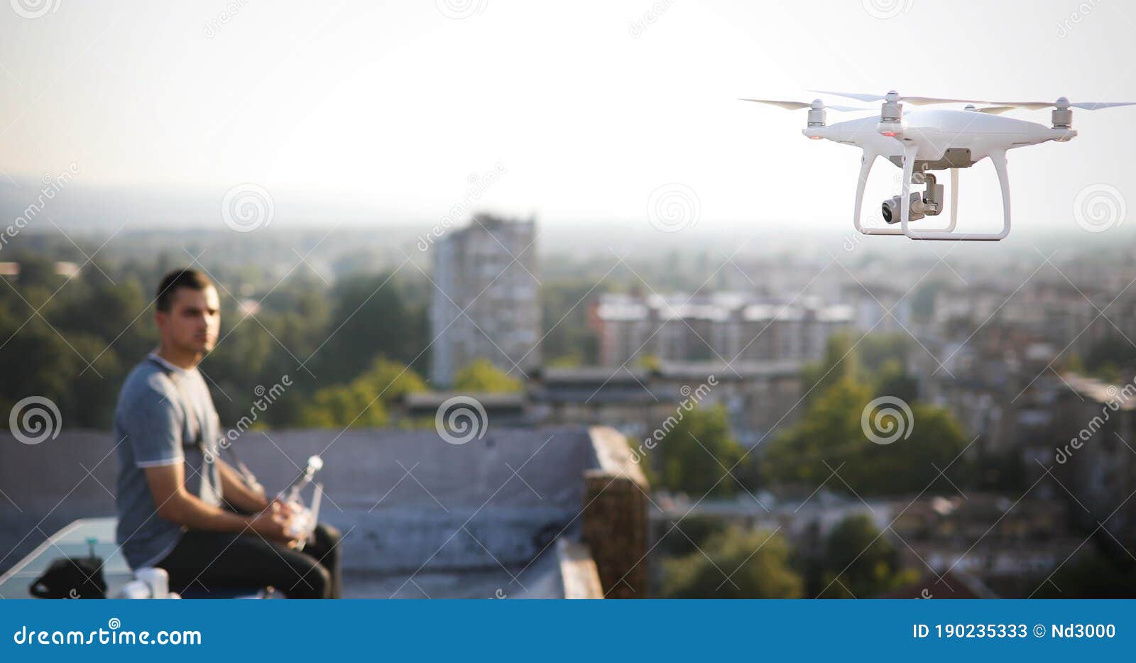 Young Technician Flying UAV Drone with Remote Control on Rooftop Stock ...