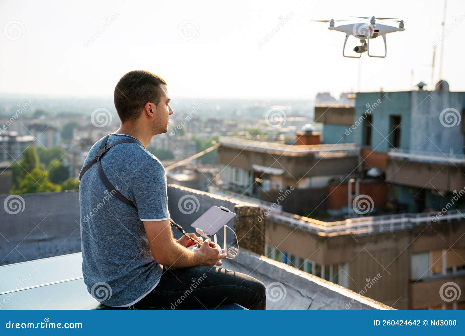 Young Technician Flying UAV Drone with Remote Control on Rooftop Stock ...