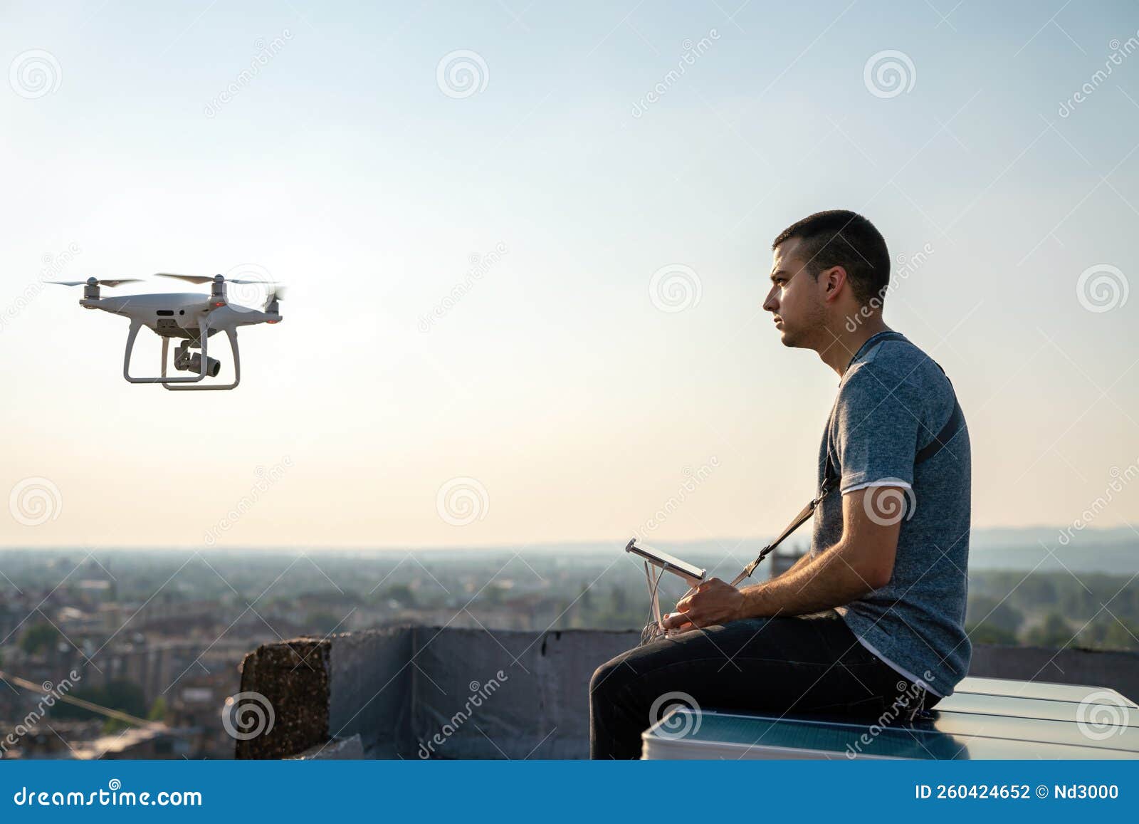 Young Technician Flying UAV Drone with Remote Control on Rooftop Stock ...