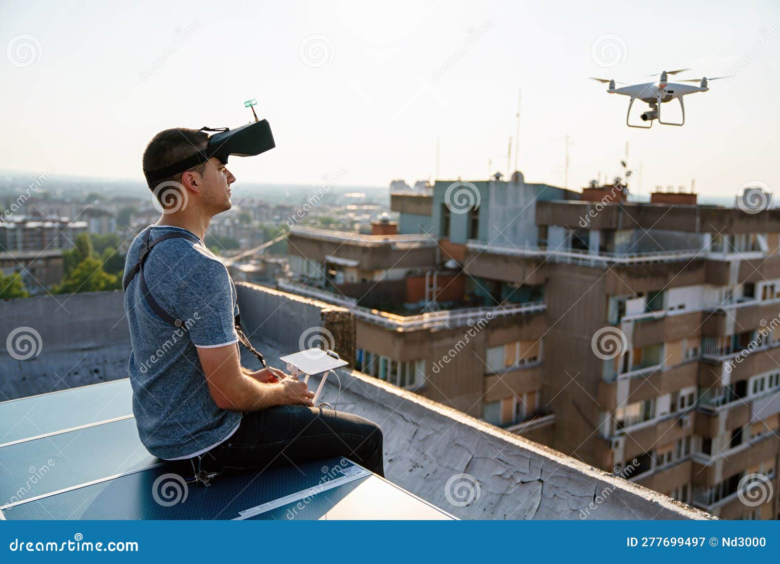 Young Technician Flying UAV Drone with Remote Control on Rooftop Stock ...