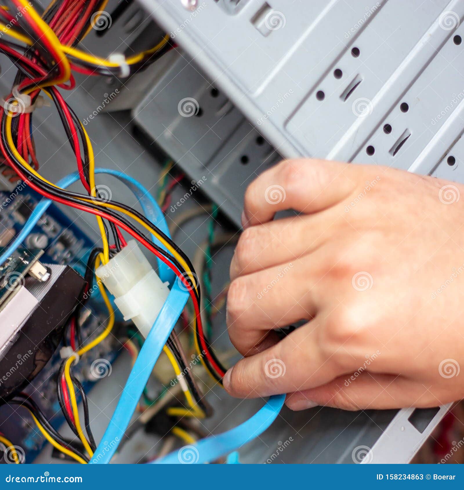 The Young Technician Hold the Cord for Repairing the Computer in His ...