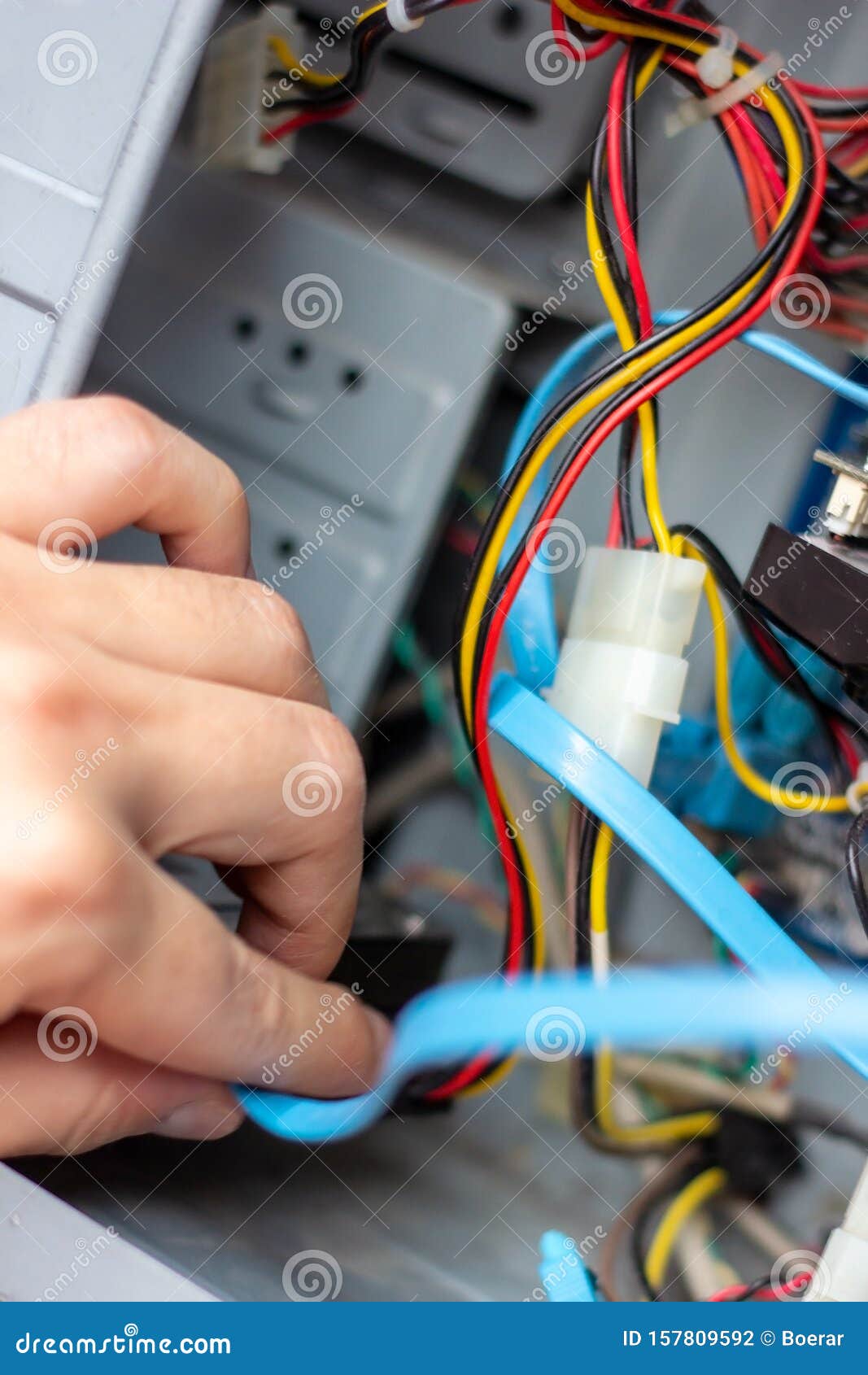The Young Technician Hold the Cord for Repairing the Computer in His ...