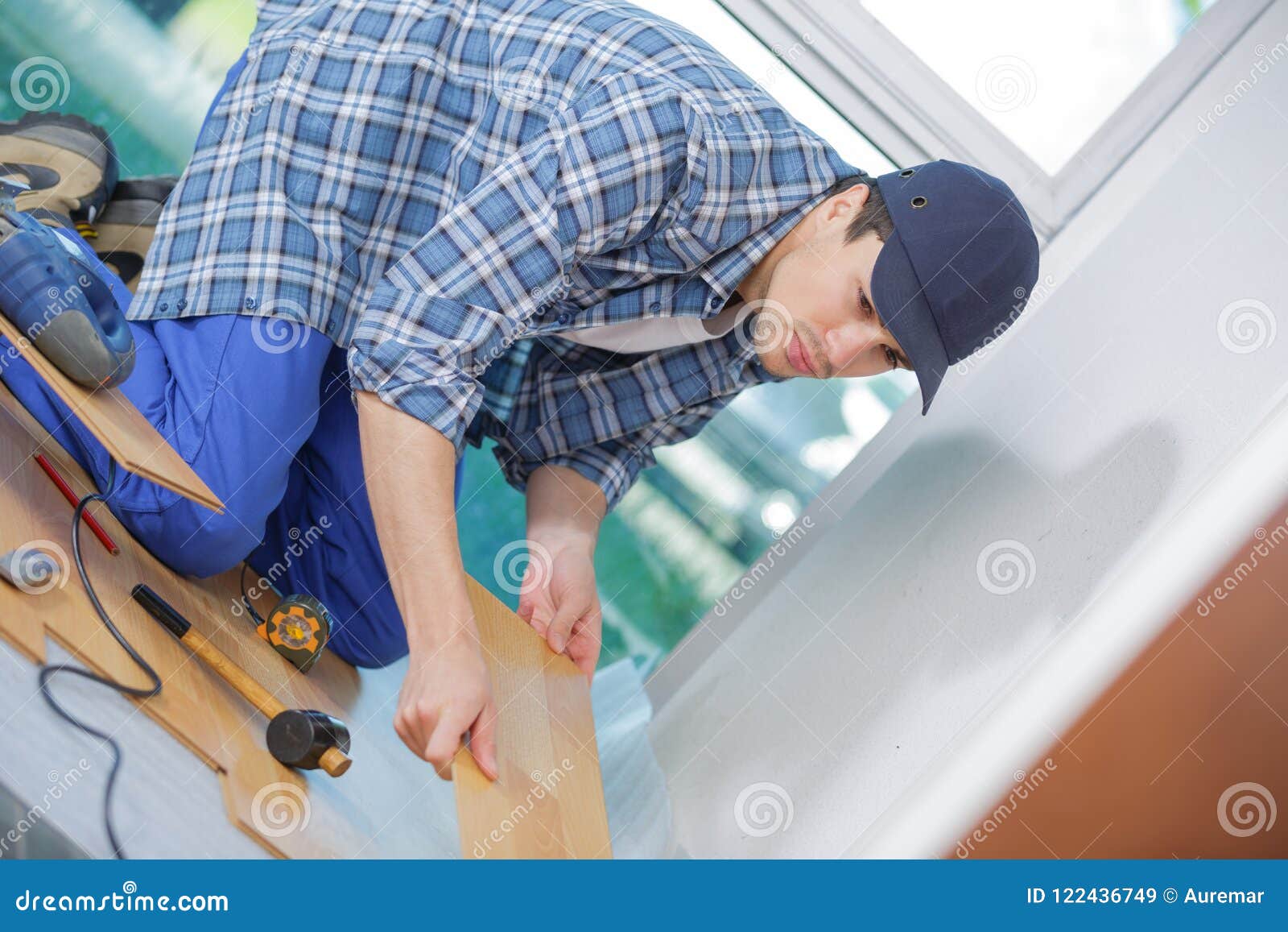 Young Technician Installing Floor at Construction Site Stock Image ...