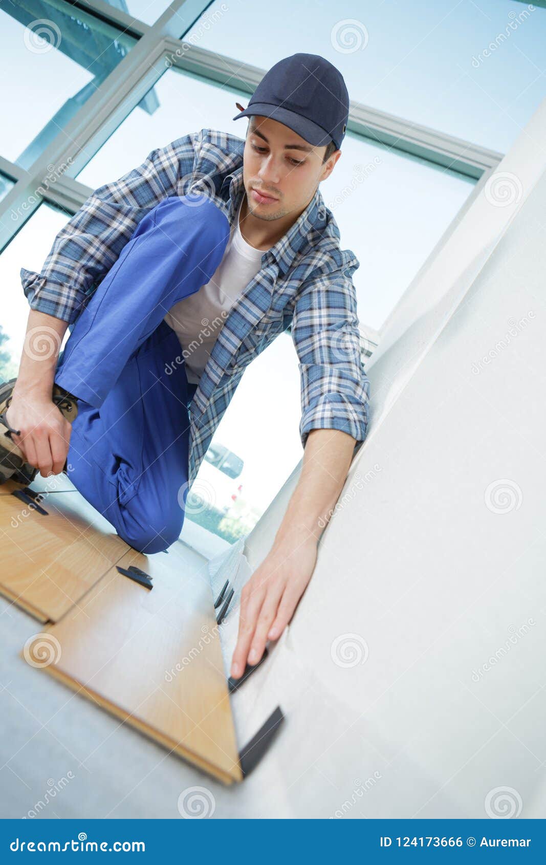 Young Technician Installing Floor at Construction Site Stock Photo ...