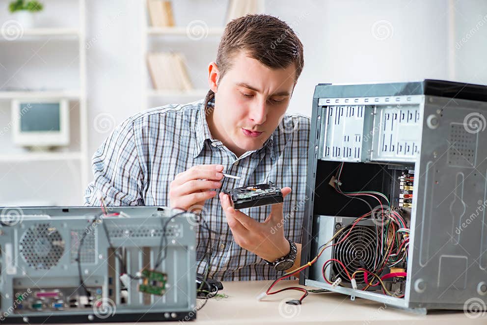 The Young Technician Repairing Computer in Workshop Stock Photo - Image ...
