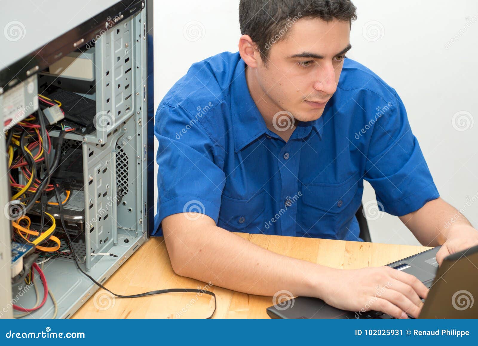 Young Technician Working on Broken Computer in His Office Stock Image ...