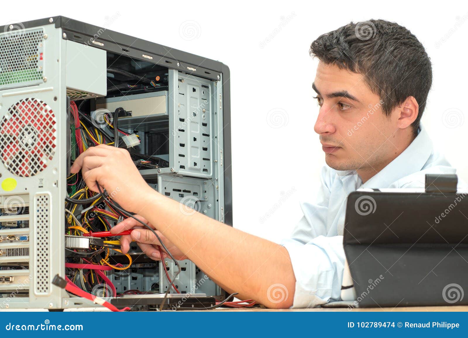 Young Technician Working on Broken Computer in His Office Stock Photo ...