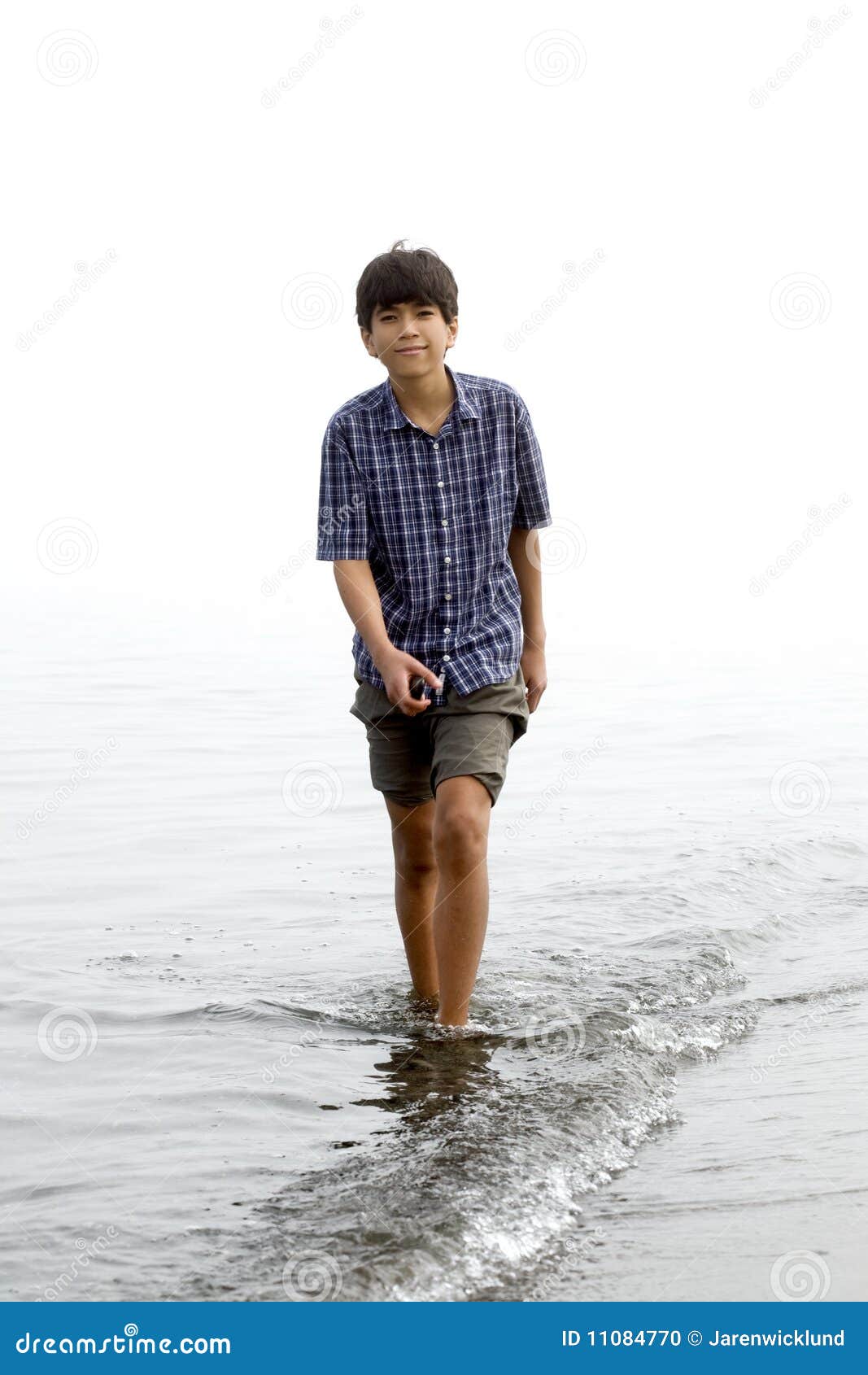 Young Teen Boy Wading Along Beach Stock Photo - Image of outdoors ...