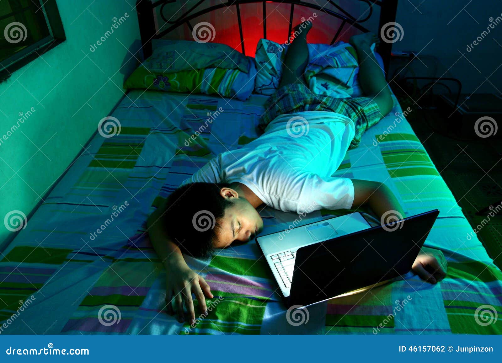 Young Teen Sleeping Front of a Laptop Computer and on a Bed Stock Photo ...