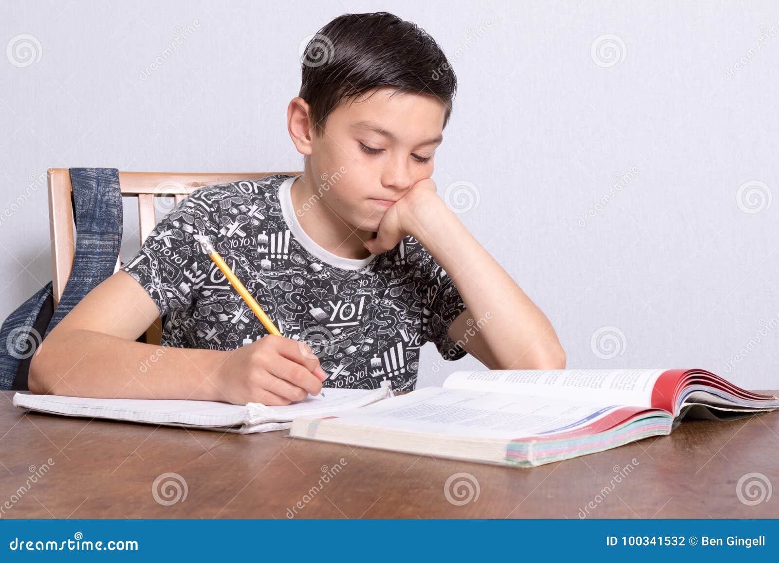 Young Teenage Boy Doing His Homework Stock Photo - Image of textbook ...