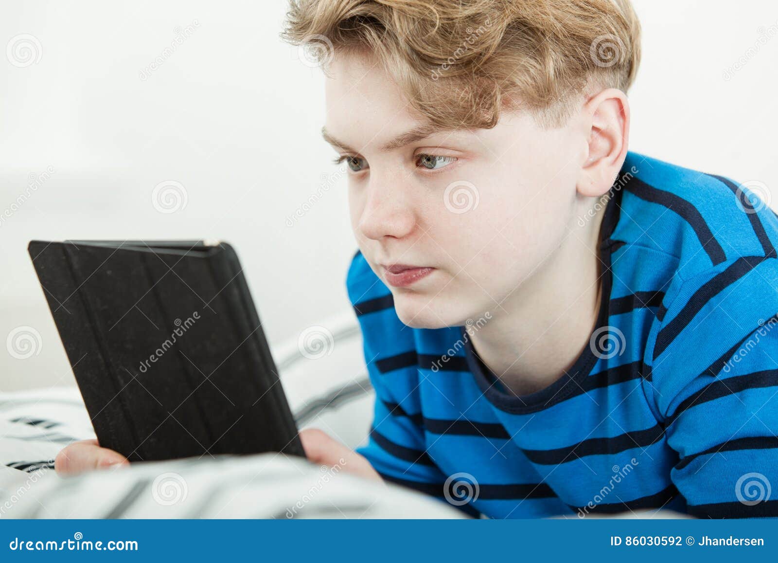 Young Teenage Boy Using a Tablet Pc Stock Photo - Image of hobby ...