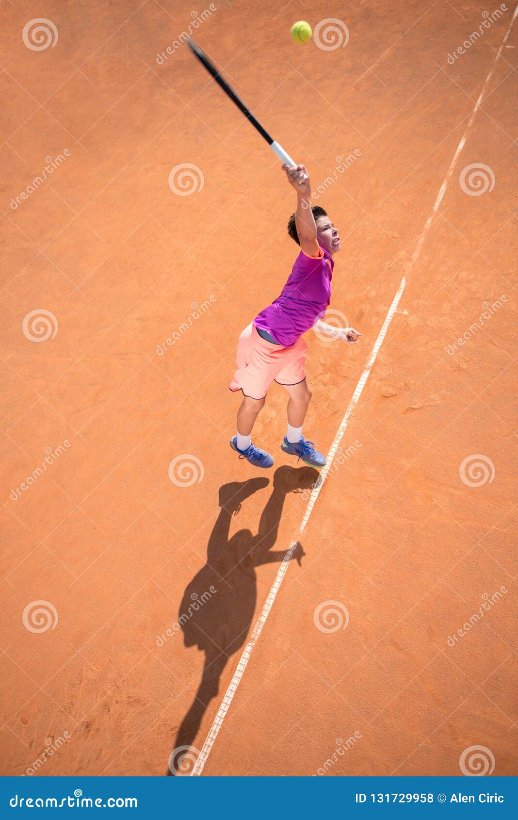 Young Tennis Player Serving the Ball with High Impact Stock Photo ...