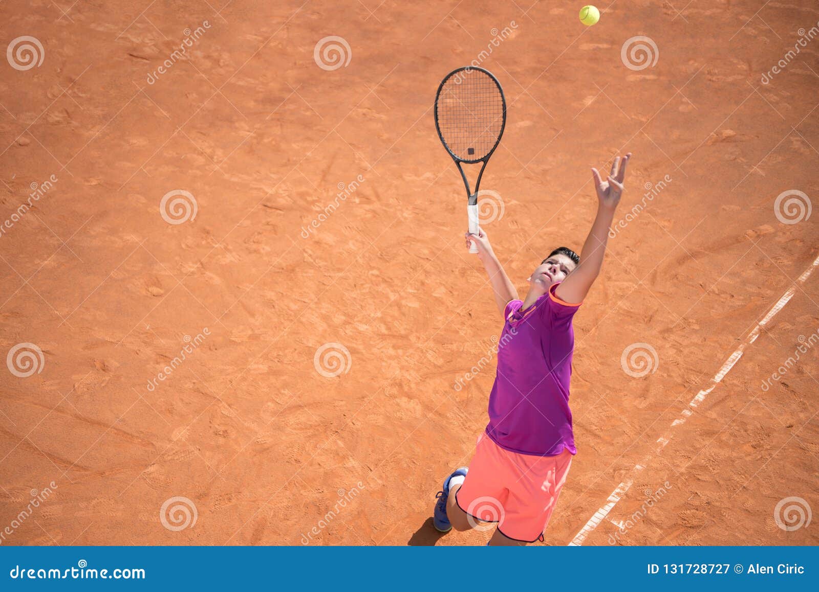 Young Tennis Player Serving the Ball with High Impact Stock Image ...