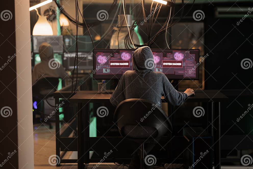 Young Thief Working To Hack Computer System on Multi Monitors Stock ...
