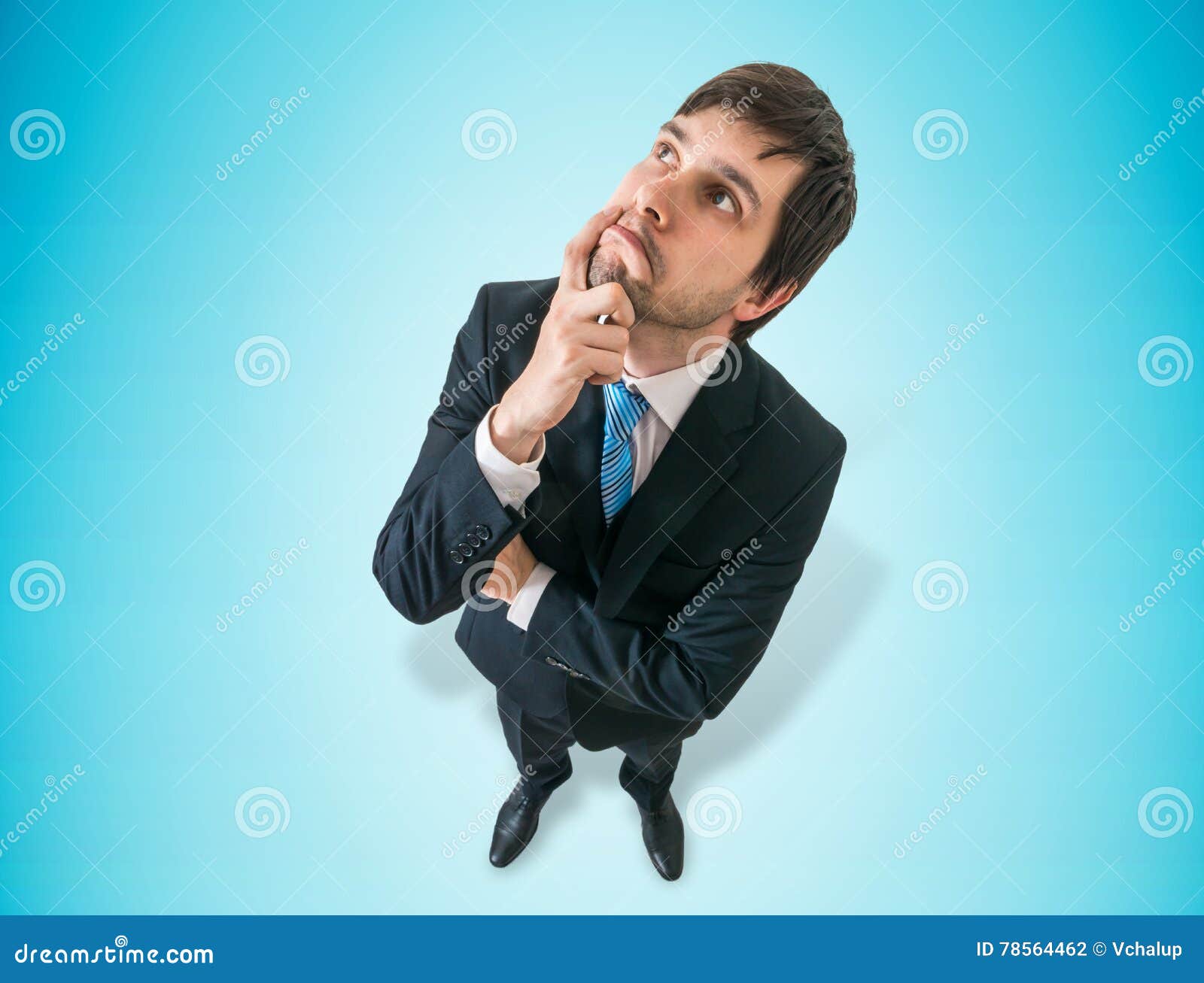 Young Thoughtful Businessman is Thinking on Blue Background Stock Photo ...