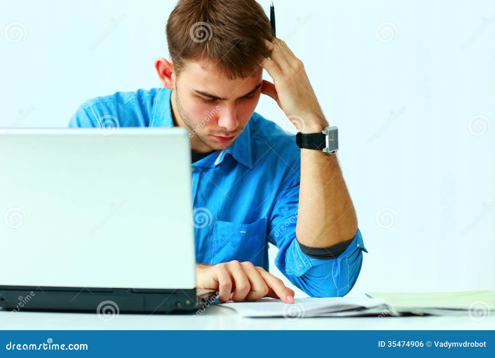 Young Thoughtful Casual Businessman Reading Document Stock Photo ...