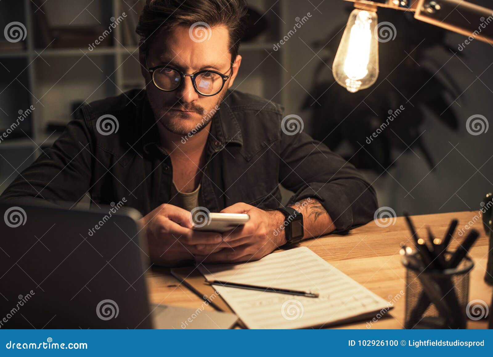 Thoughtful Composerusing Smartphone Stock Photo - Image of fashion ...