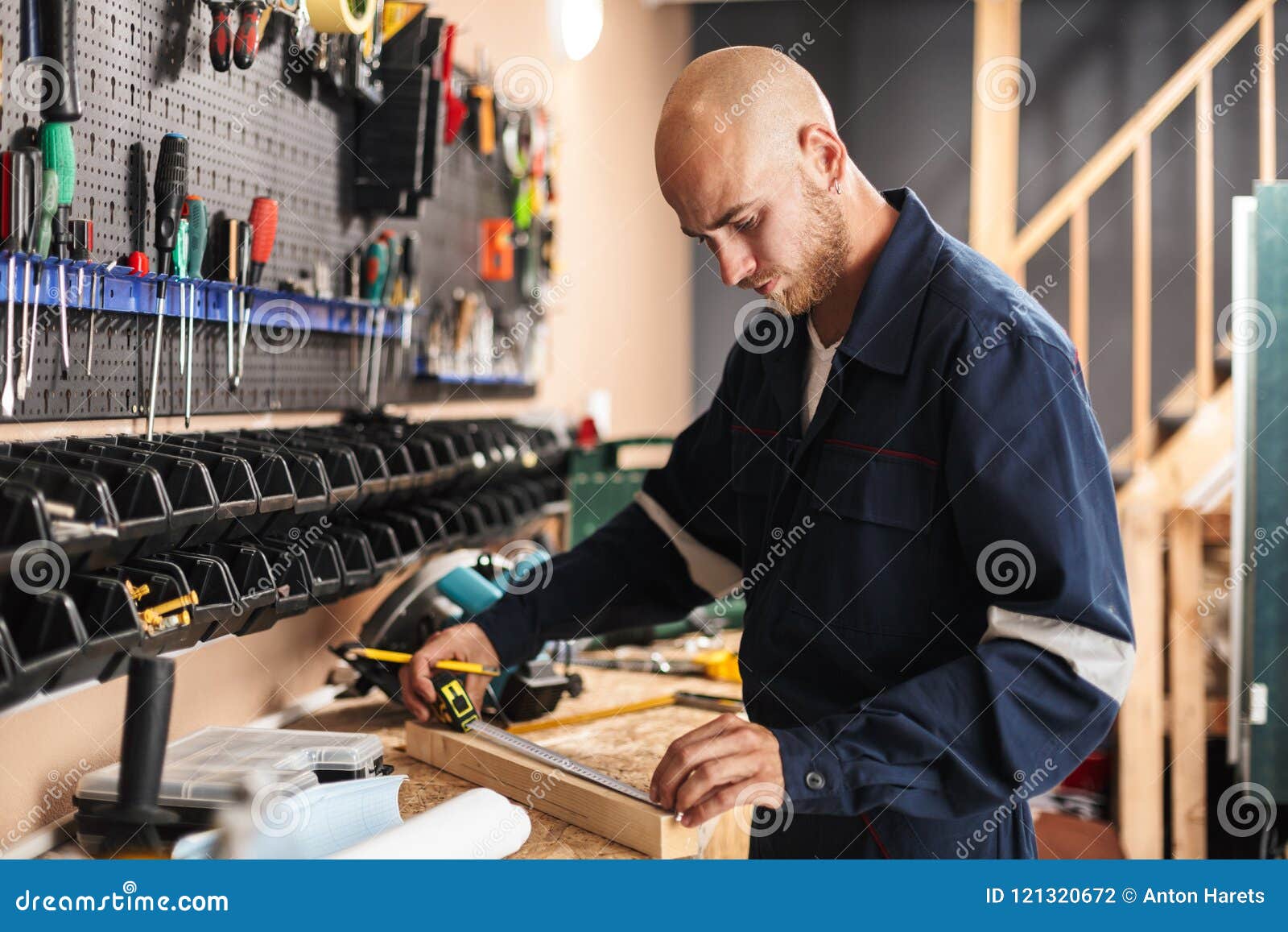 Young Foreman in Work Clothes Using Measuring Tape Spending Time Stock ...