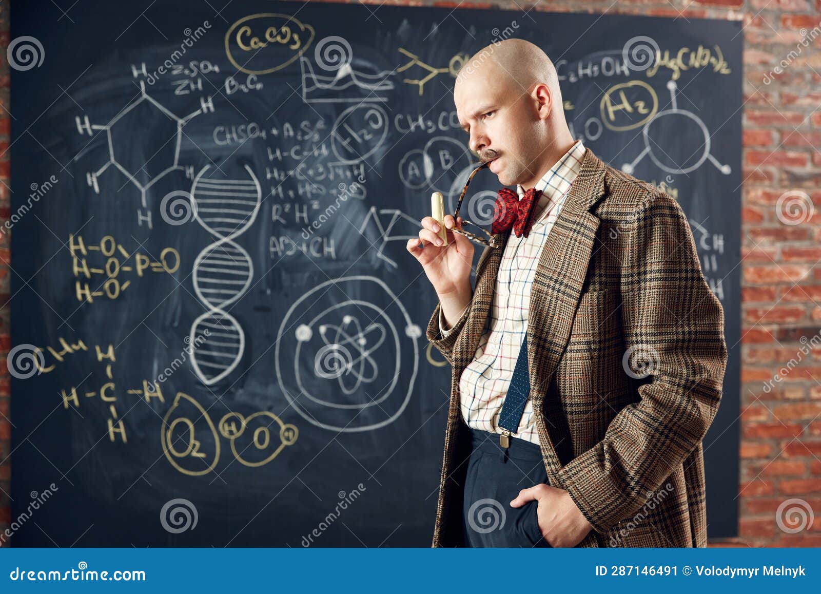 Young Thoughtful Man, Scientist Standing at Blackboard with Formulas ...