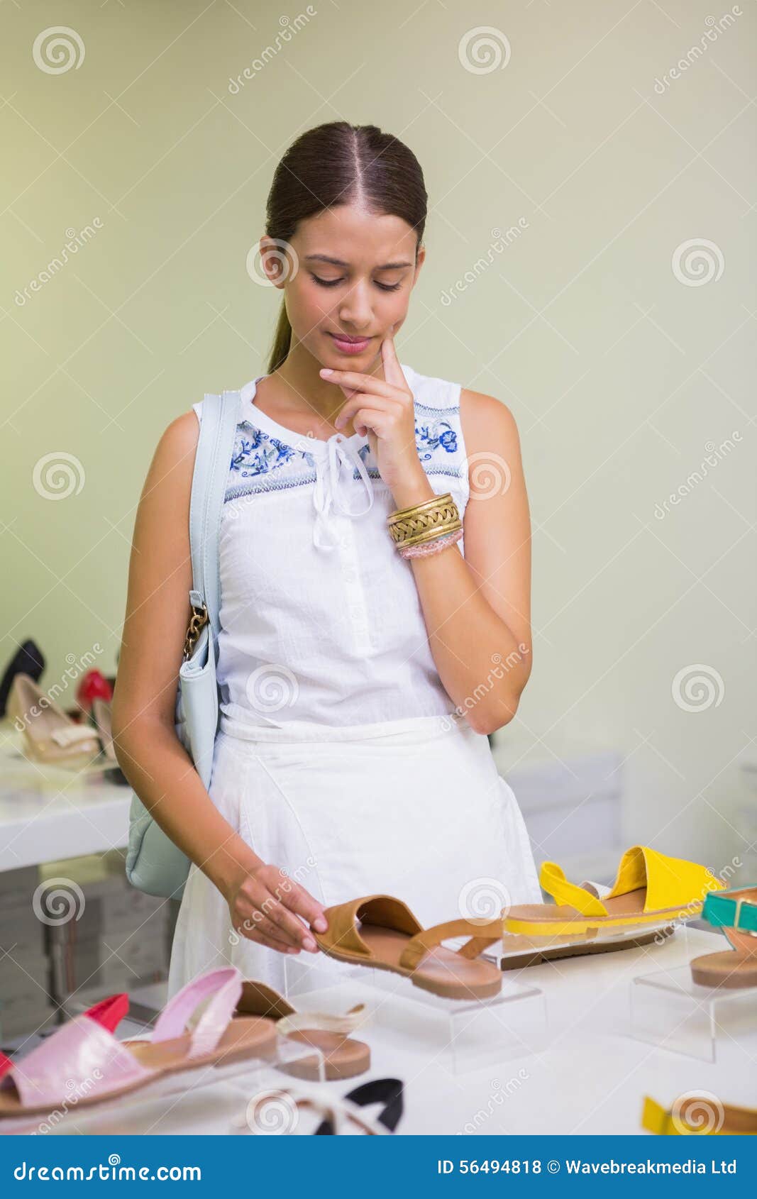 Young Thoughtful Woman Looking at a Shoe Stock Photo - Image of ... Young Thoughtful Woman Looking at a Shoe Stock Photo - Image of ...
