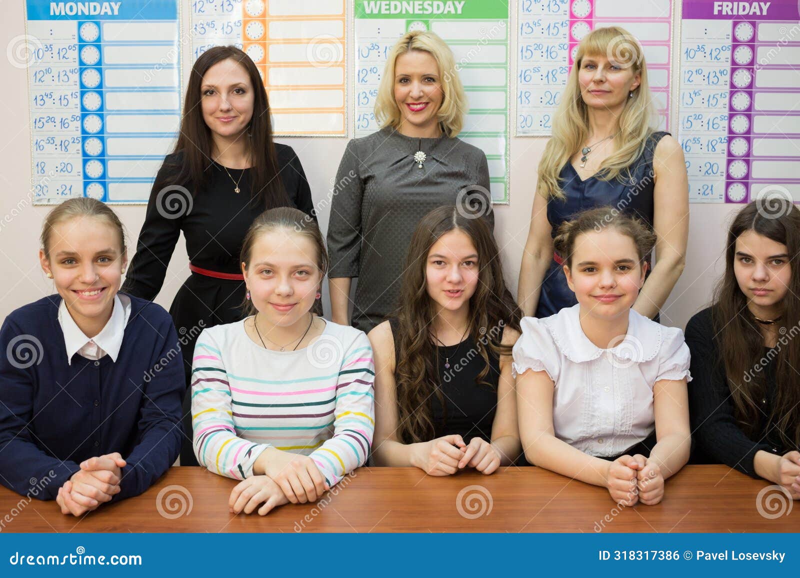 Young Three Teachers are Standing Next To the Wall Stock Photo - Image ...