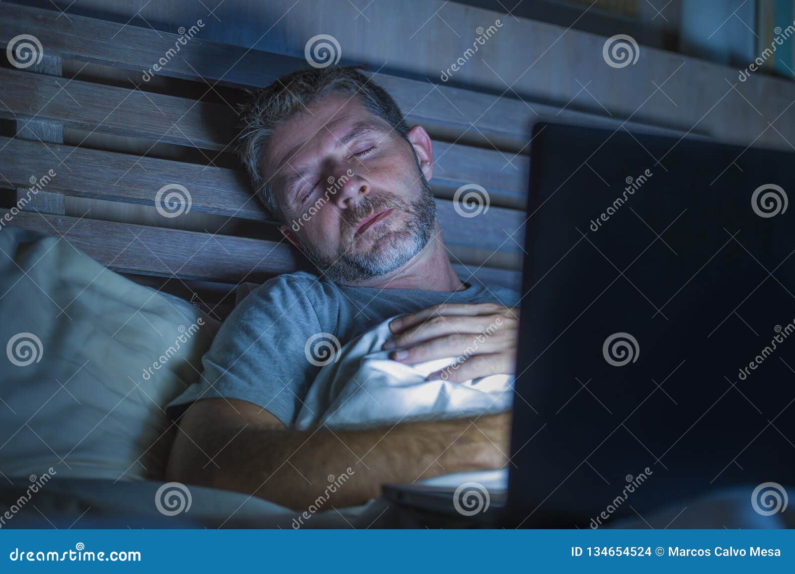 Young Tired and Exhausted Internet or Work Addict Man Sleeping while ...