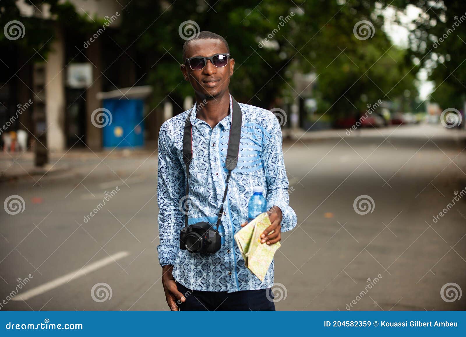 Young Tourist Holding a Map Stock Image - Image of handsome, holding ...