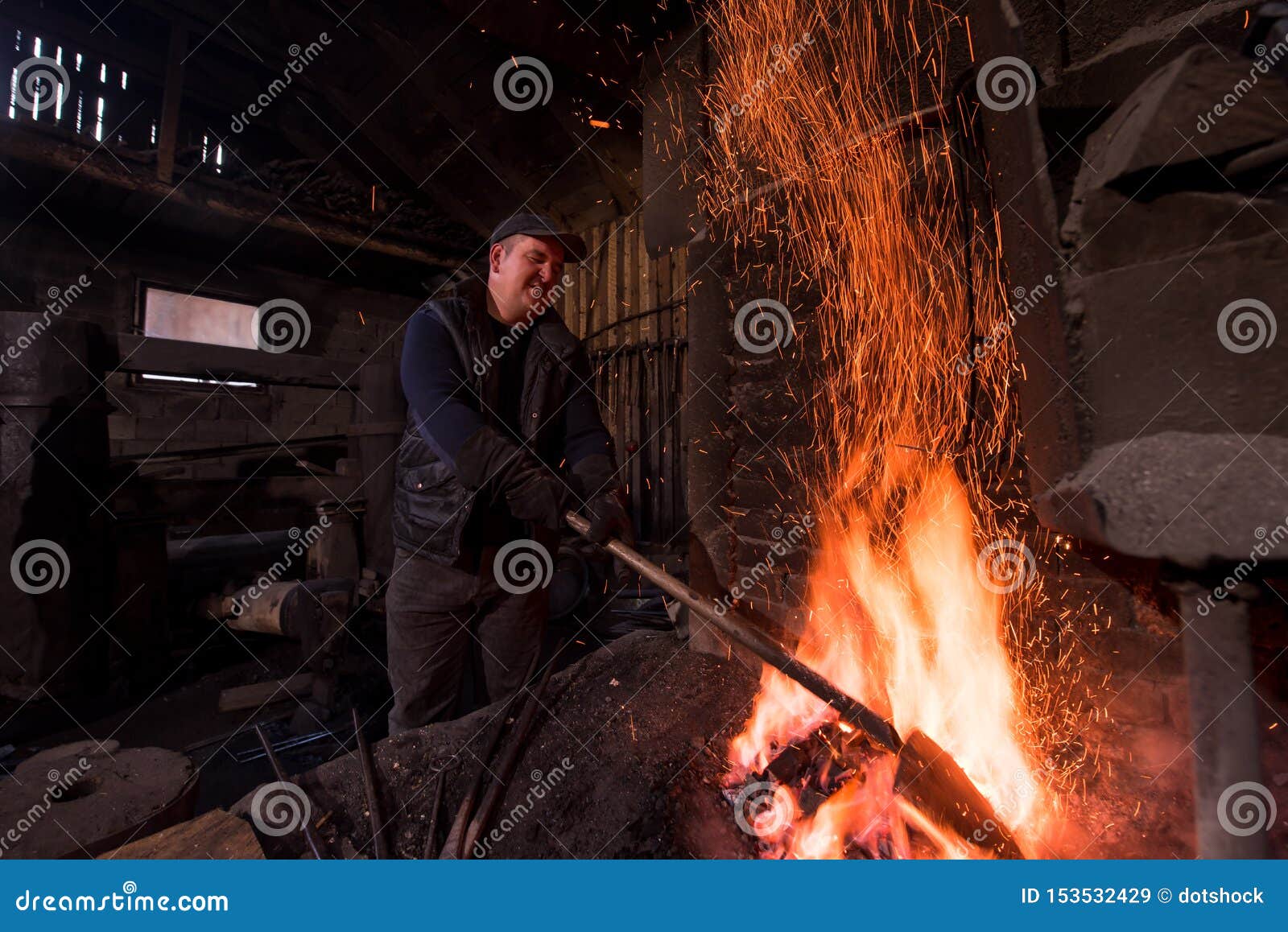 Traditional Blacksmith Uses Bellows To Keep A Fire Royalty-Free Stock ...