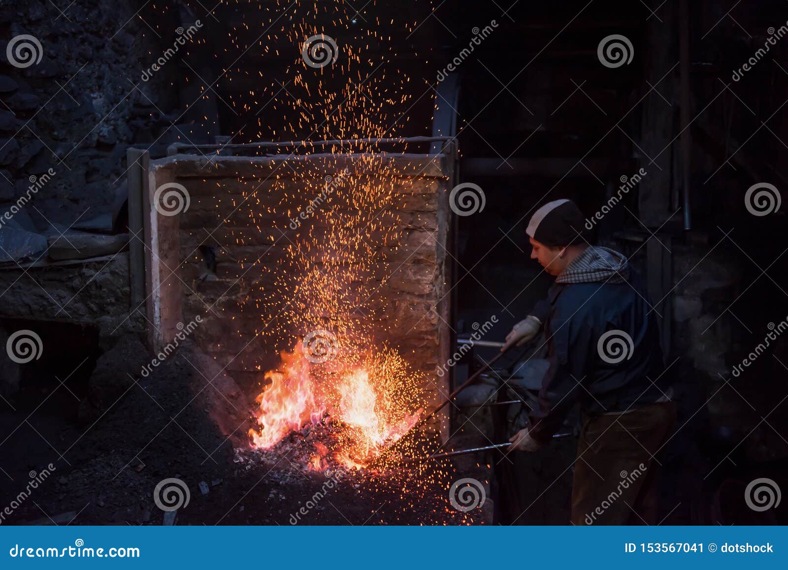 Traditional Blacksmith Uses Bellows To Keep A Fire Royalty-Free Stock ...