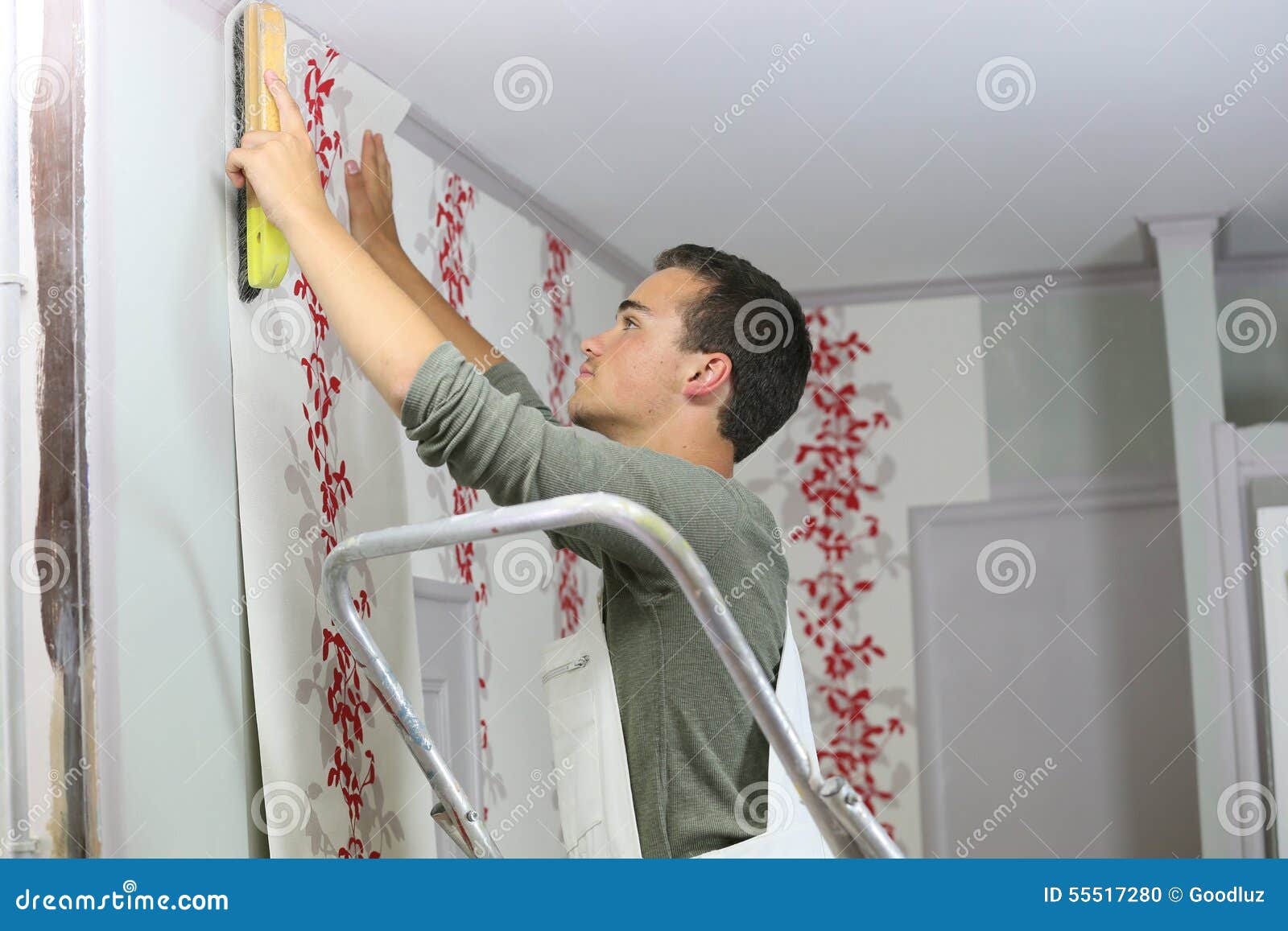 Young Trainee Putting Wallpaper Stock Photo - Image of wall, student ...