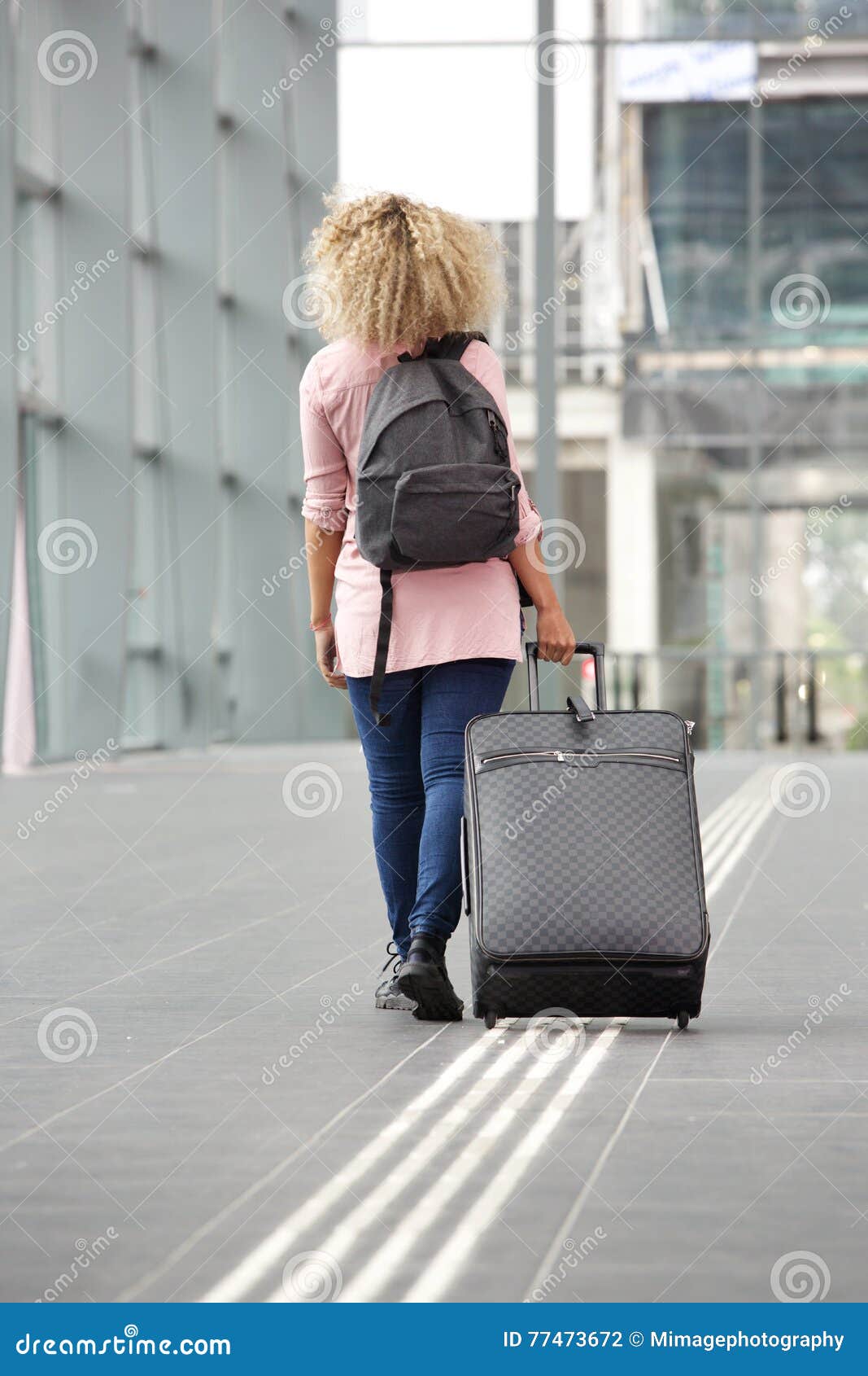 Young Traveler Walking Away with Suitcase and Backpack Stock Photo ...