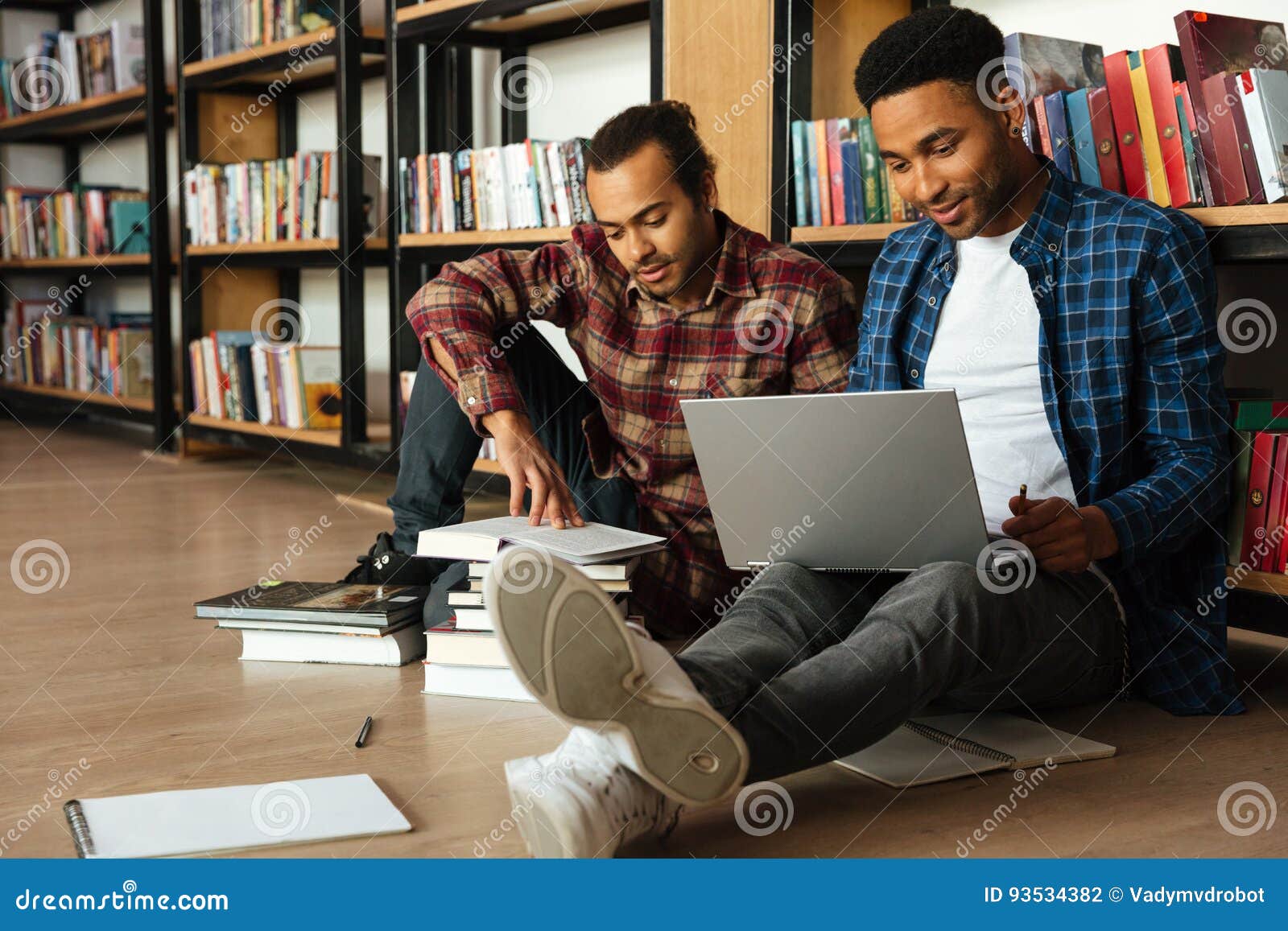 Young Two African Men Reading Books Using Laptop Computer Stock Photo ...