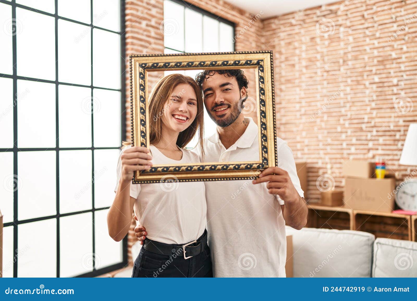 Young Two People Holding Empty Frame Together Winking Looking at the ...