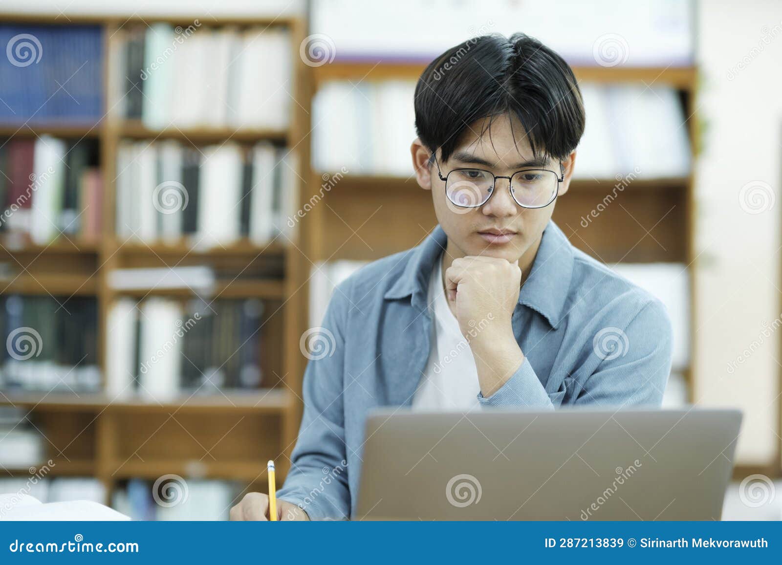 Young University Student Using Laptop for Online Learning, Searching ...