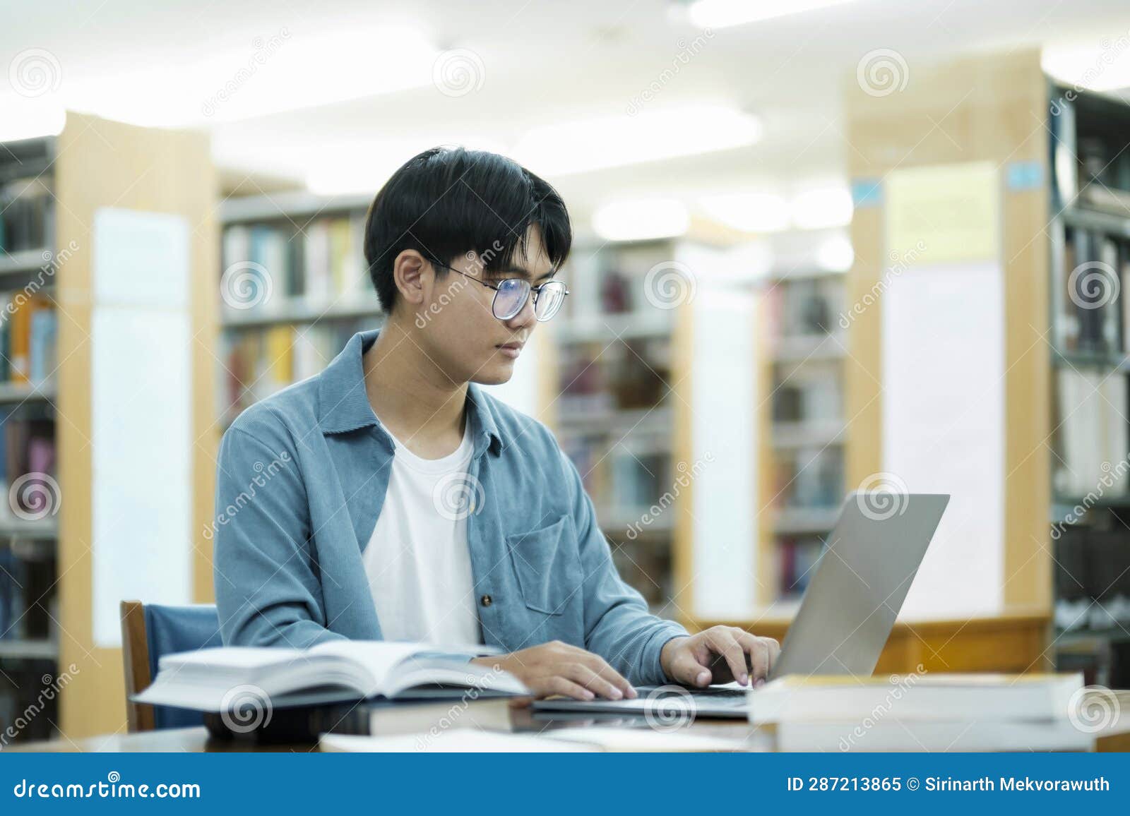 Young University Student Using Laptop for Online Learning, Searching ...
