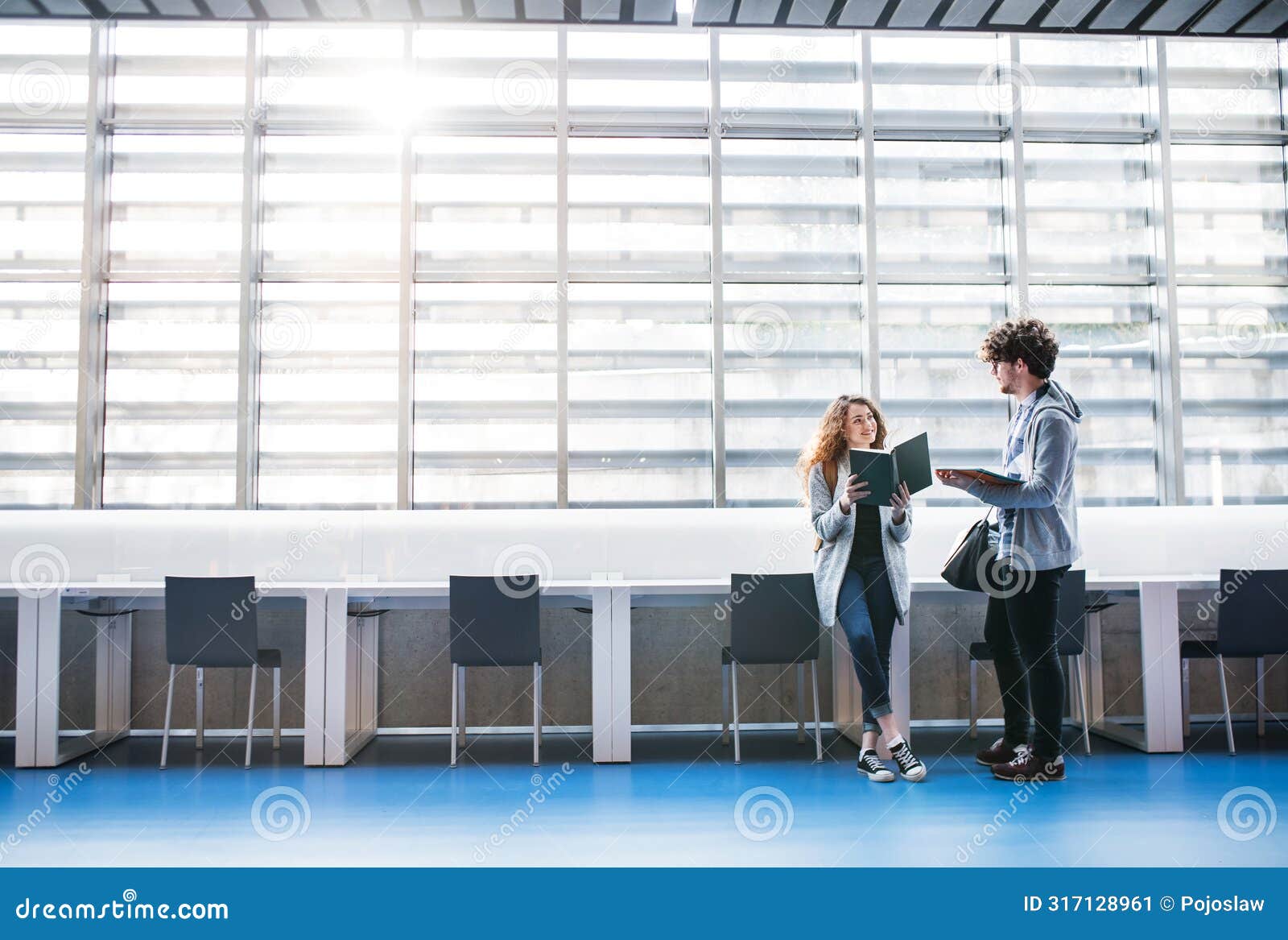 Young University Students Meeting in Library To Study Together ...