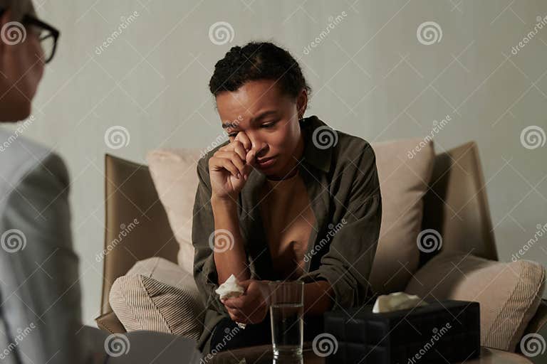 Young Upset African American Woman Wiping Her Tears While Crying Stock