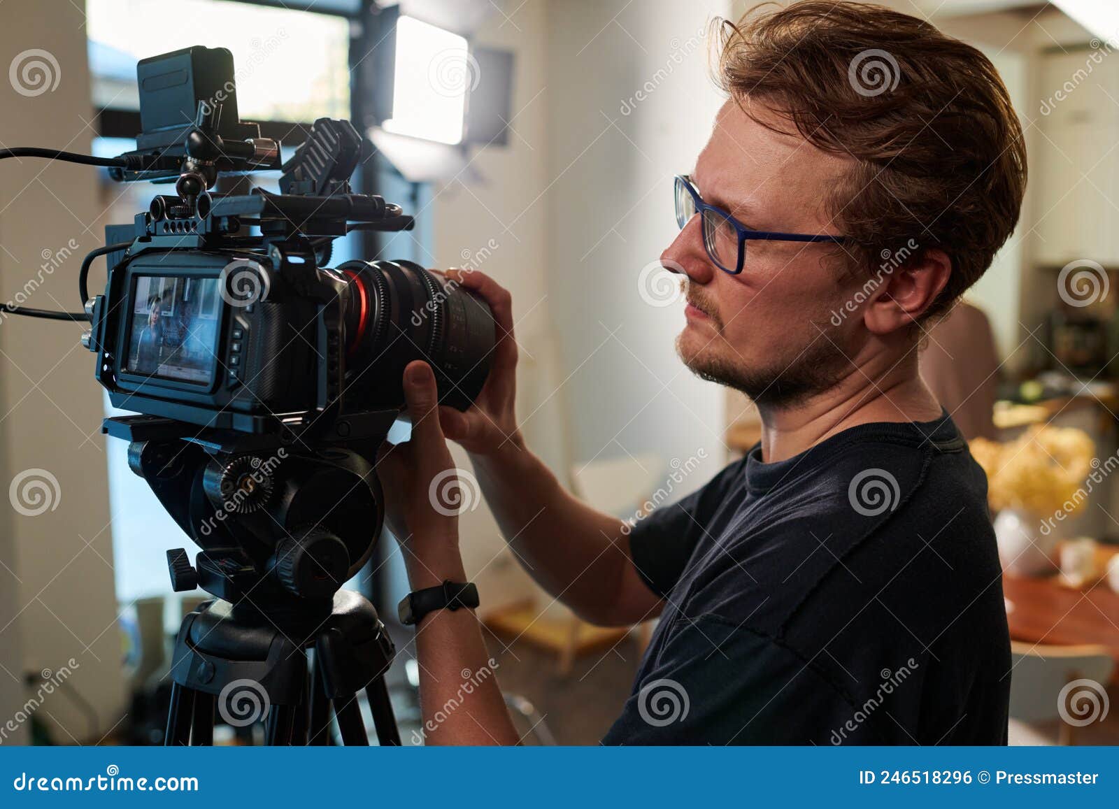 Young Videographer or Cameraman Adjusting Focus of His Video Camera ...