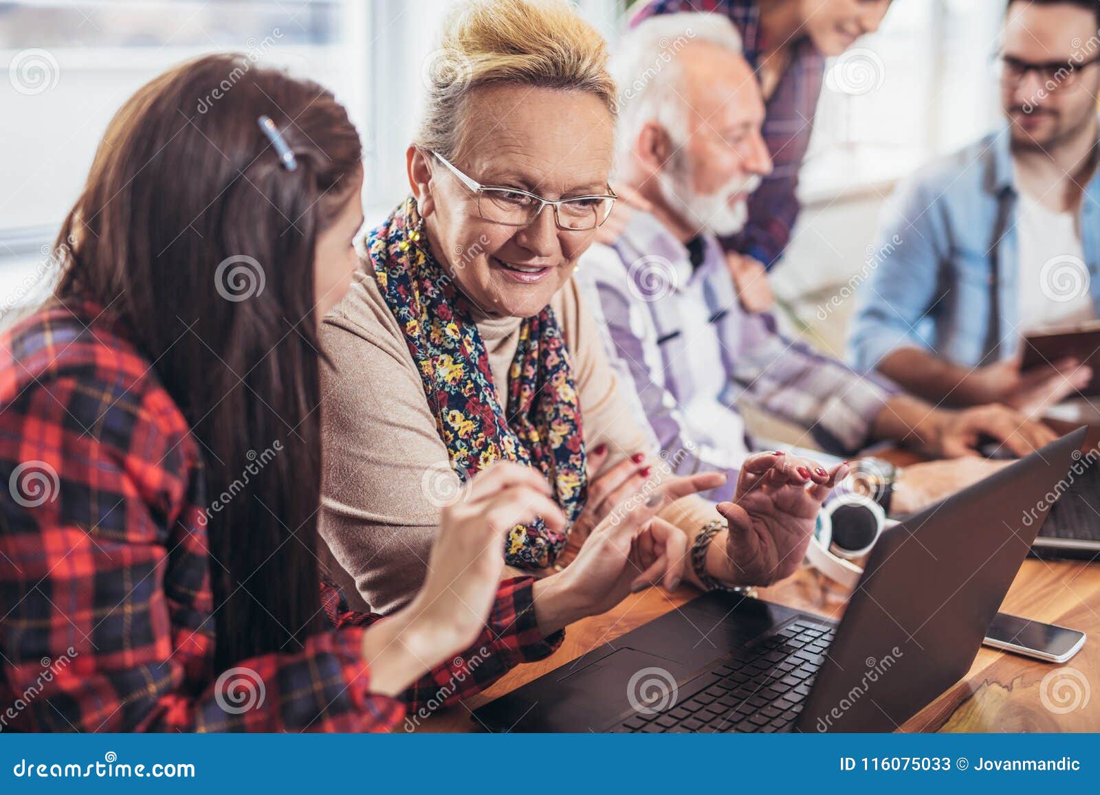 Young Volunteers Help Senior People on the Computer. Stock Image ...