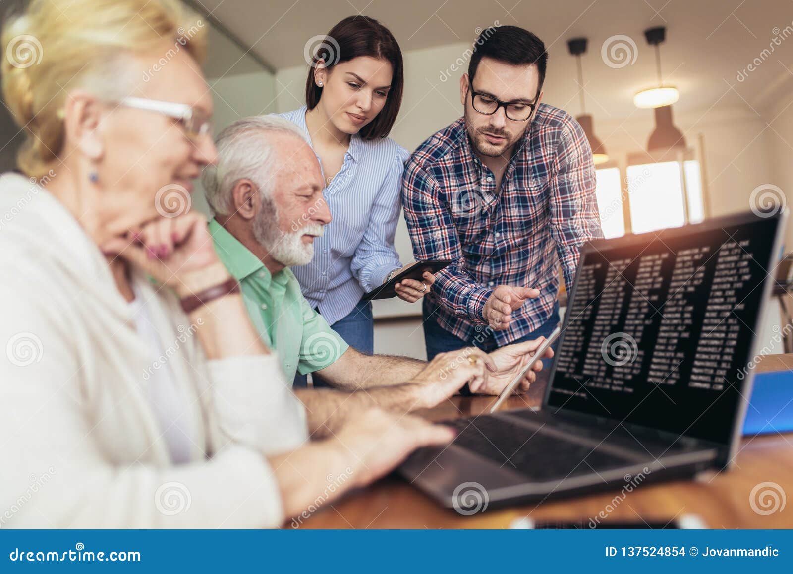 Young Volunteers Help Senior People on the Computer. Stock Photo ...