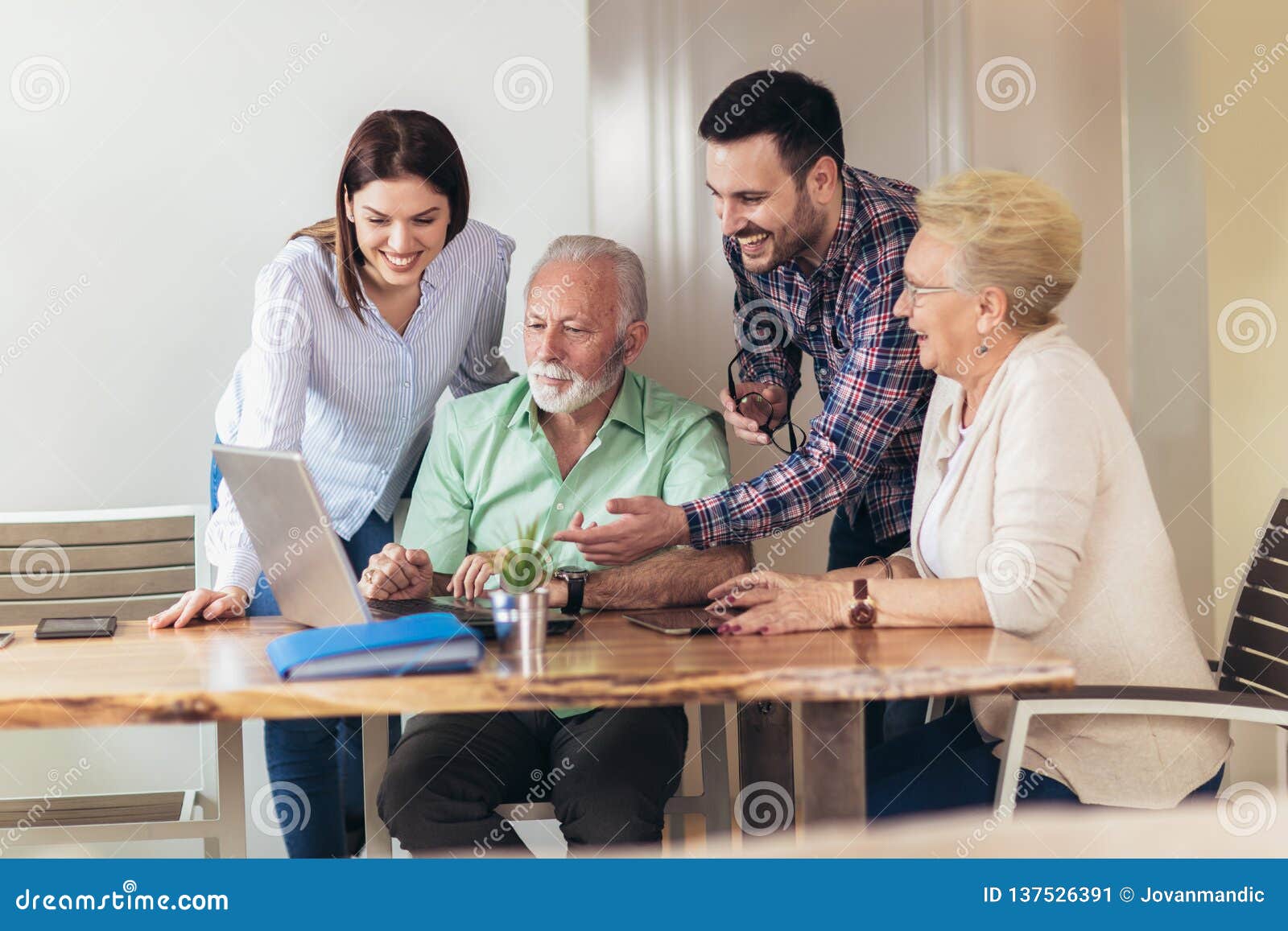Young Volunteers Help Senior People on the Computer. Stock Image ...