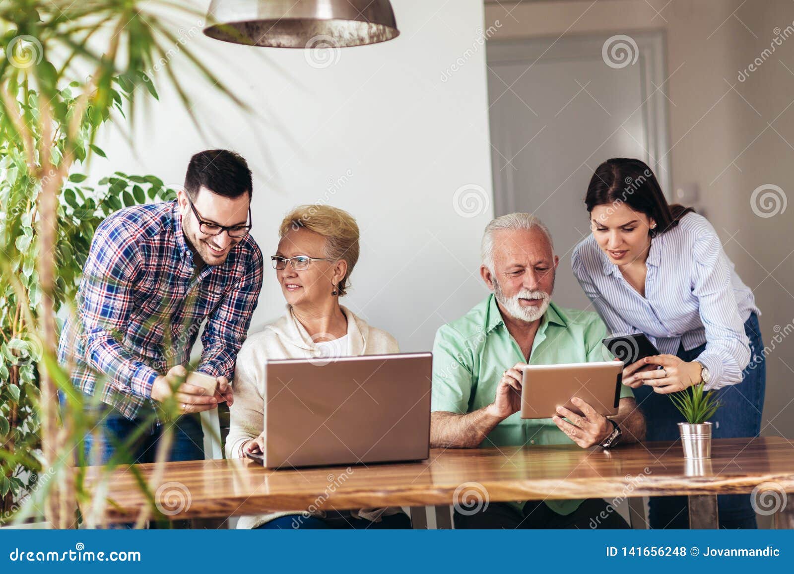 Volunteers Help Senior People on the Computer. Young People Giving ...