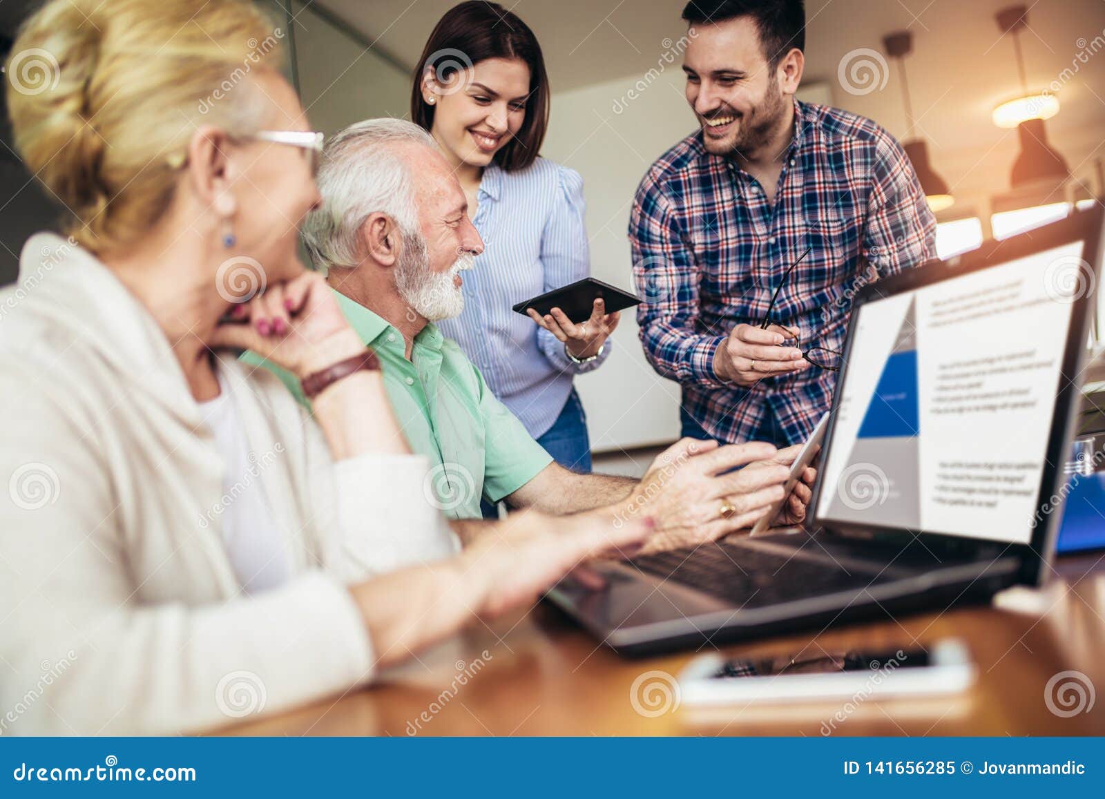 Volunteers Help Senior People on the Computer. Young People Giving ...