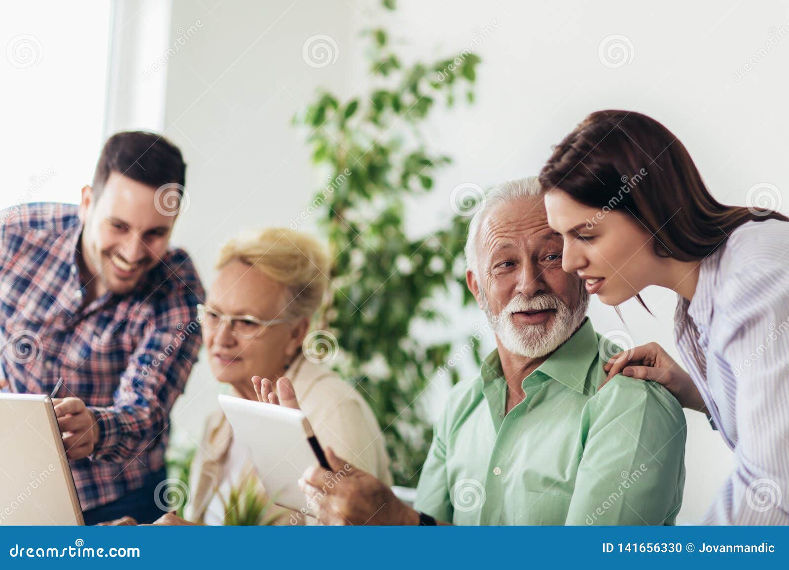 Volunteers Help Senior People on the Computer. Young People Giving ...