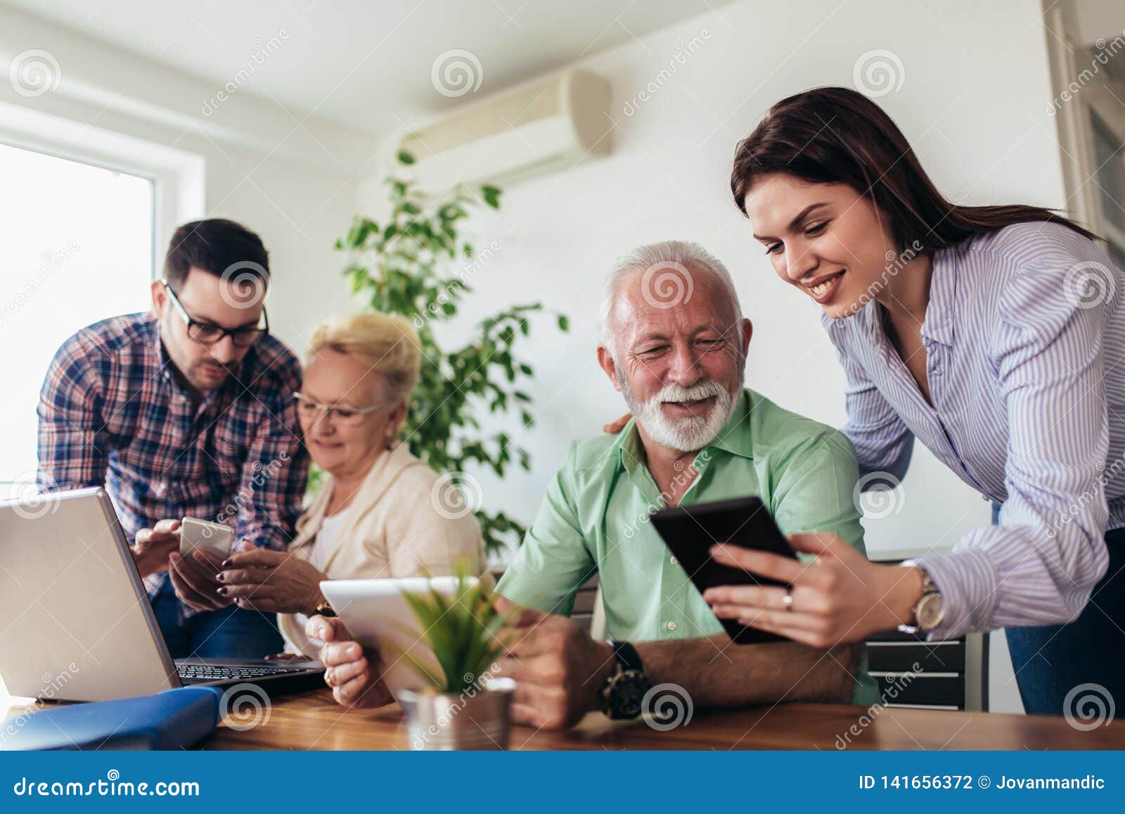 Volunteers Help Senior People on the Computer. Young People Giving ...
