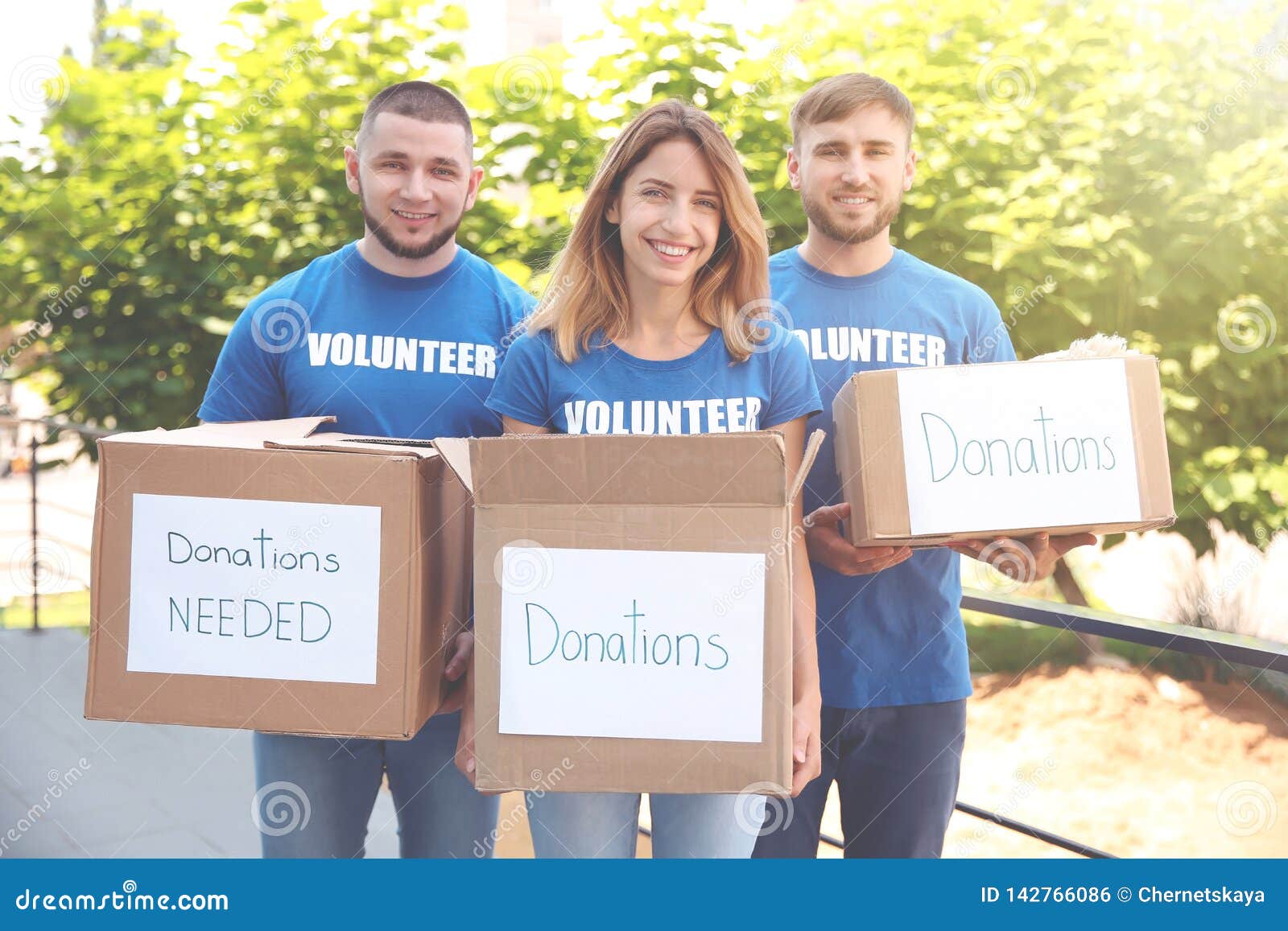 Young Volunteers Holding Boxes with Donations for Poor People Stock ...