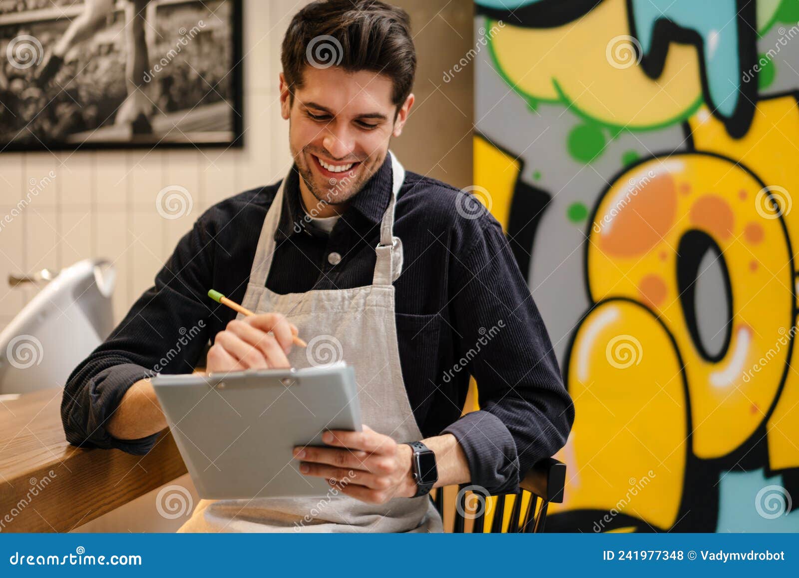 Young Waiter Checking the Quality of Goods Stock Photo - Image of ...