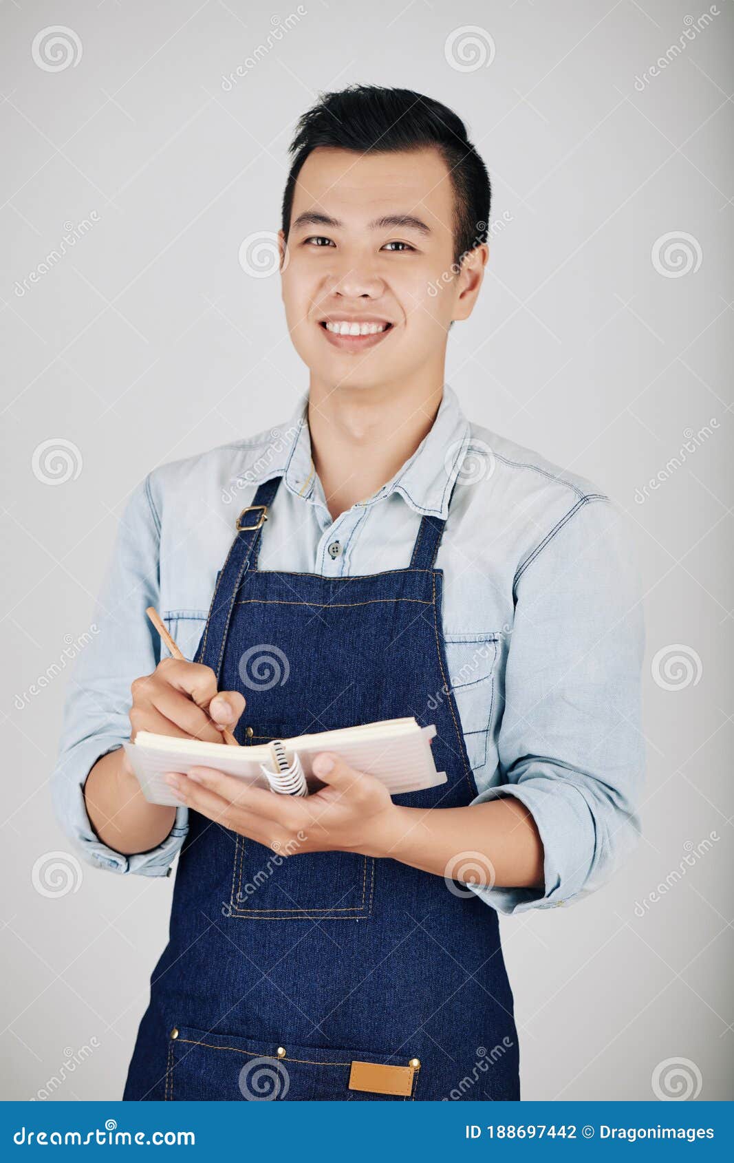 Young waiter taking notes stock photo. Image of smiling - 188697442