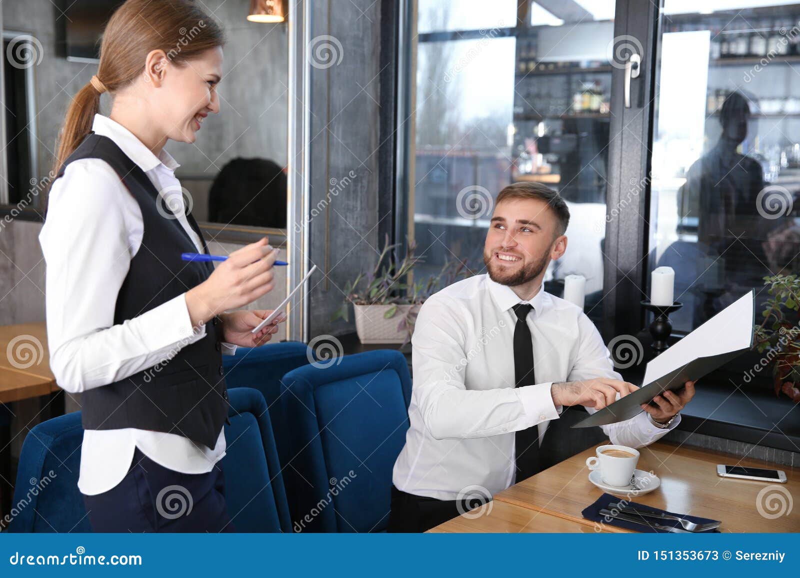 Young Waitress Taking an Order from Man in Restaurant Stock Image ...